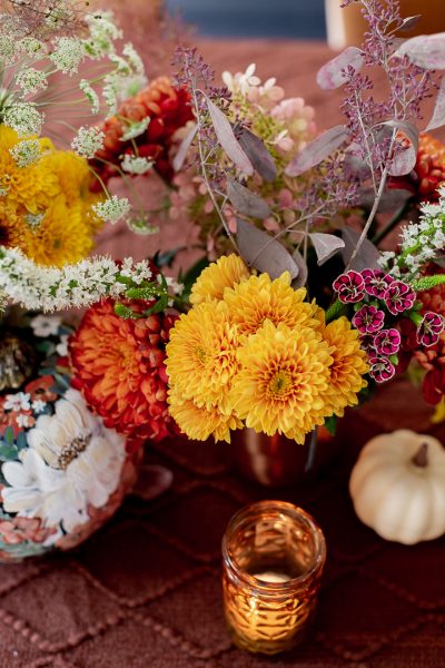 Fall centerpiece using grocery store flowers and copper canisters.